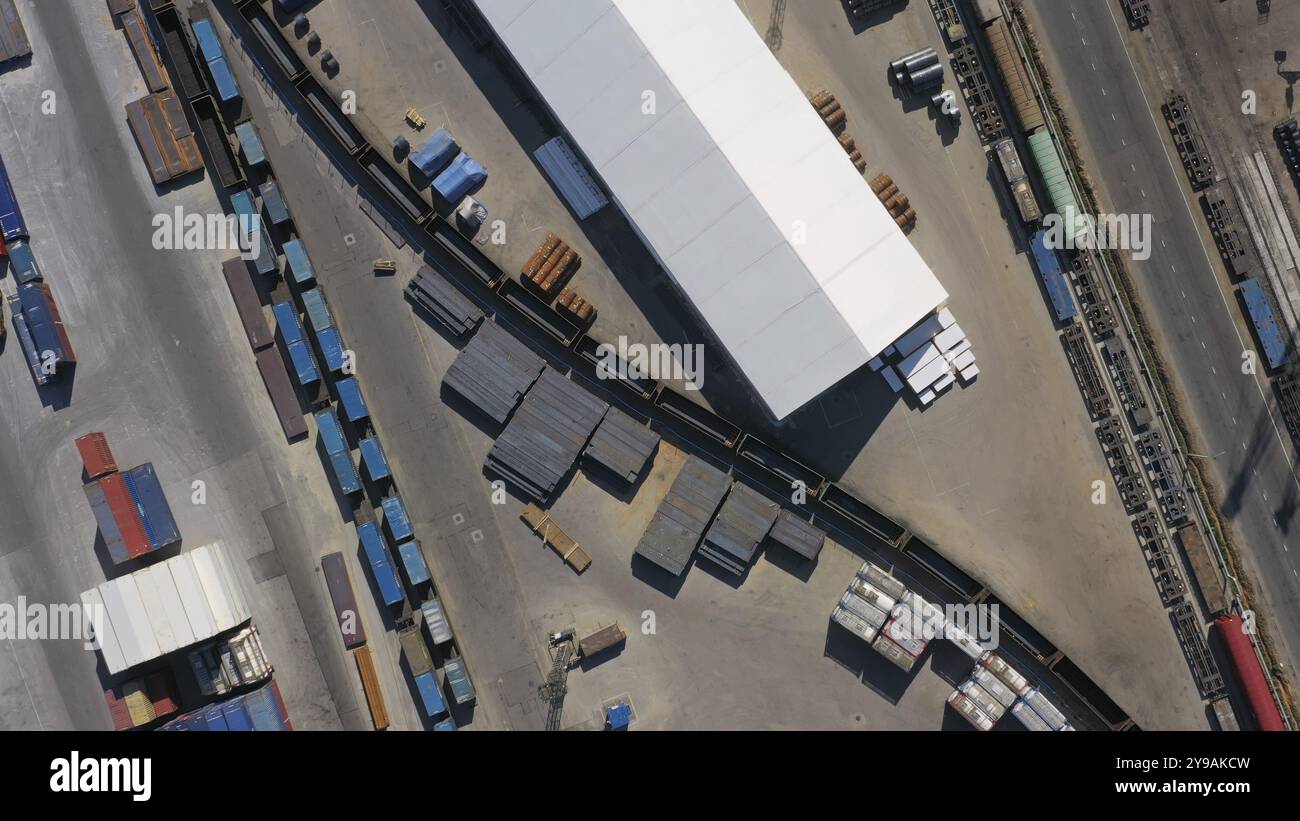 Aerial top view of cargo container terminal with railway, business ...