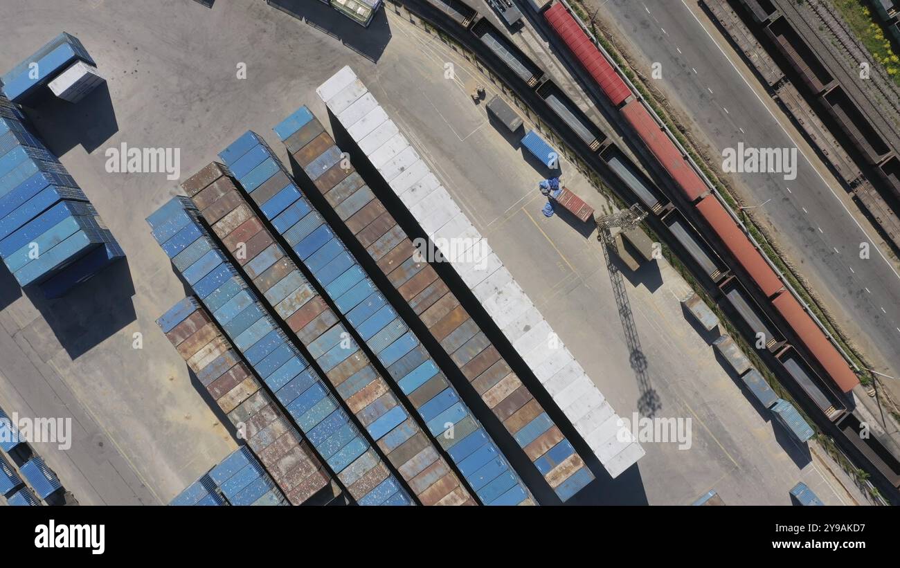 Aerial top view of cargo container terminal with railway, business ...