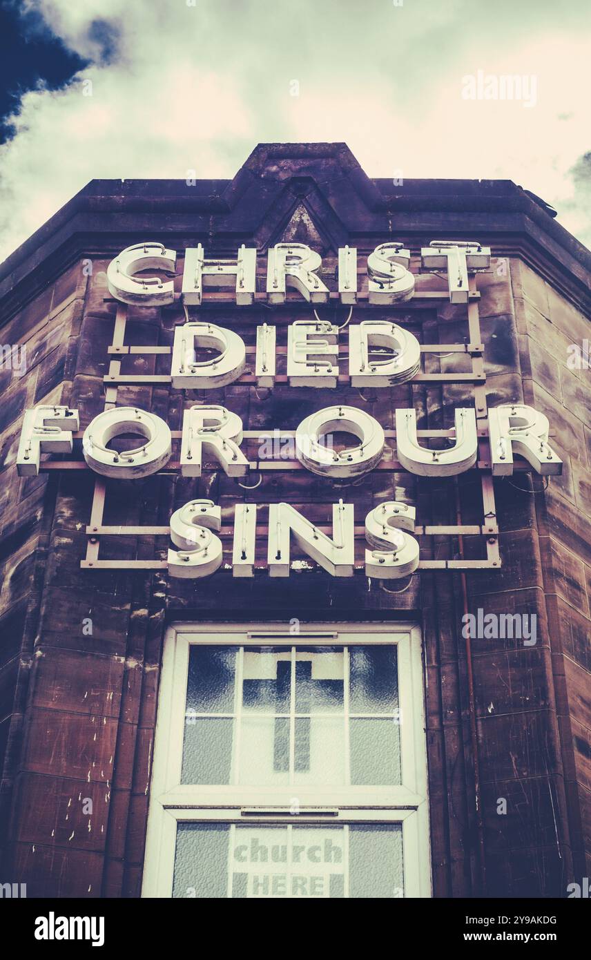A Neon Sign On An Old Building Saying Christ Died For Our Sins Stock ...