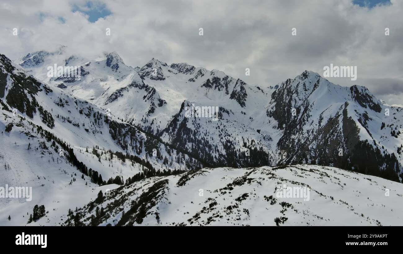 Aerial view of snow mountain range landscape with clouds. Alps ...