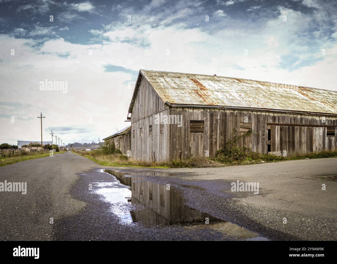 A barn reflects in a puddle left by a recent rain Stock Photo - Alamy