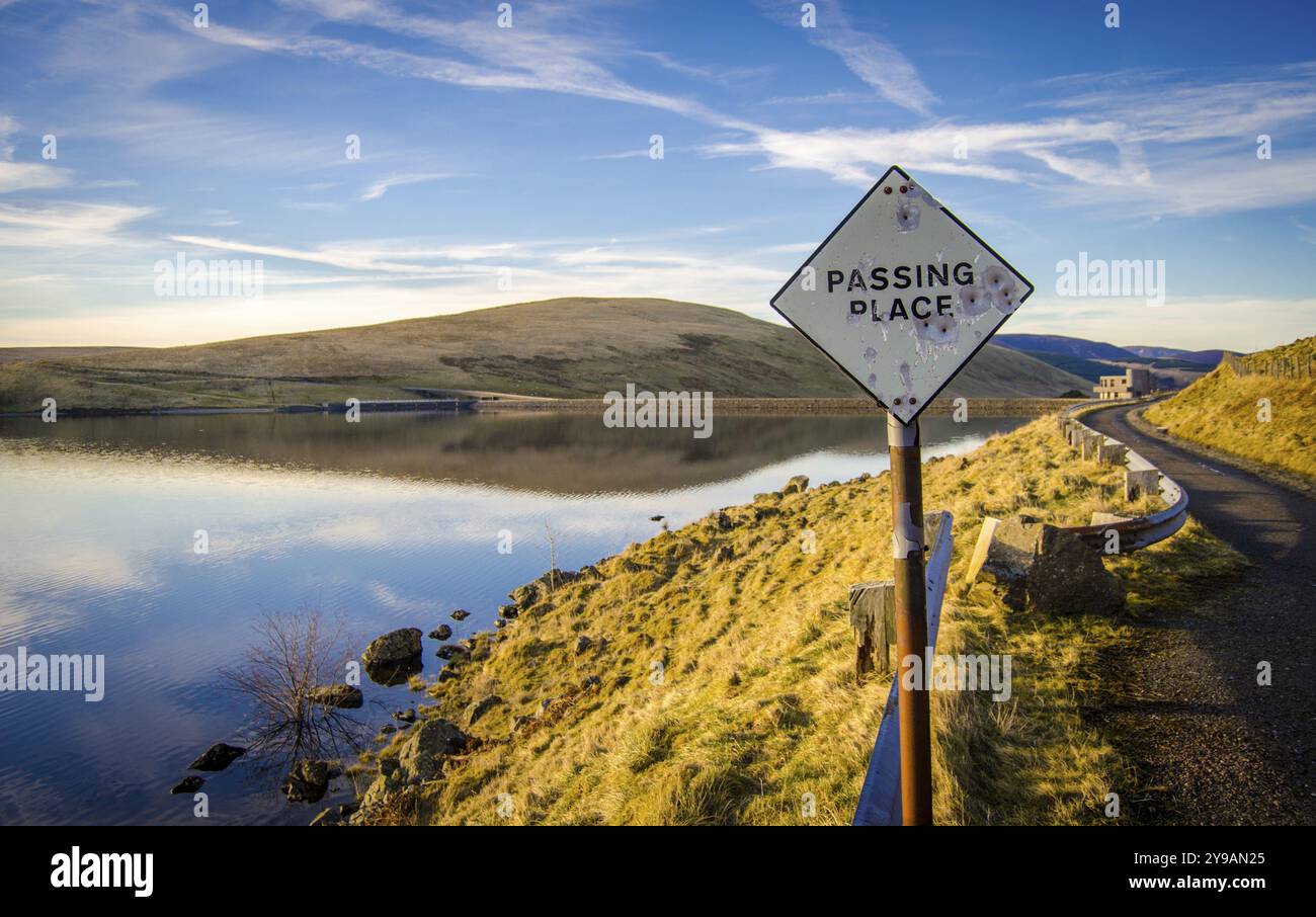 Passing Place Sign With Bullet Holes On Rural Road Beside A Lake In ...