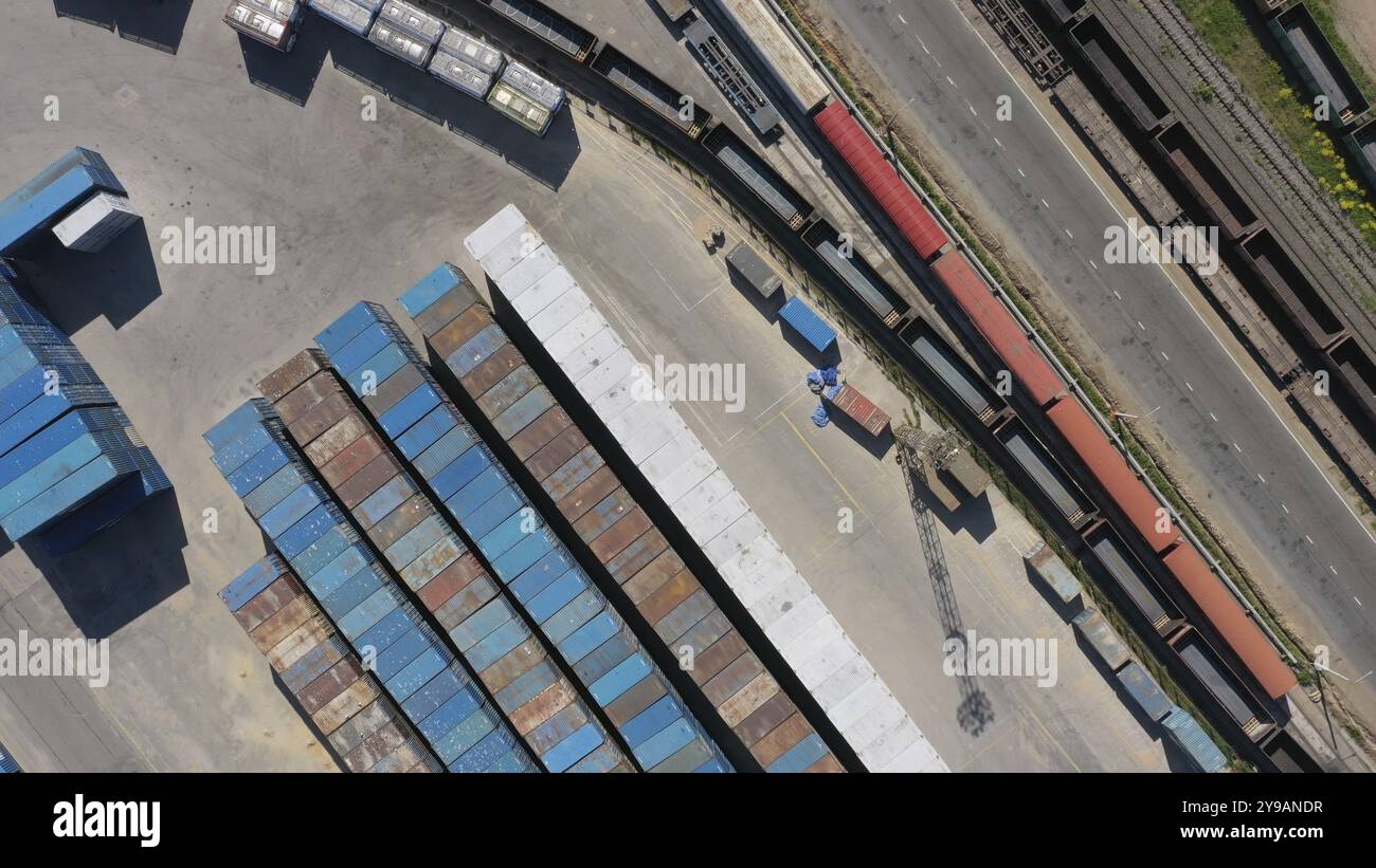 Aerial top view of cargo container terminal with railway, business ...