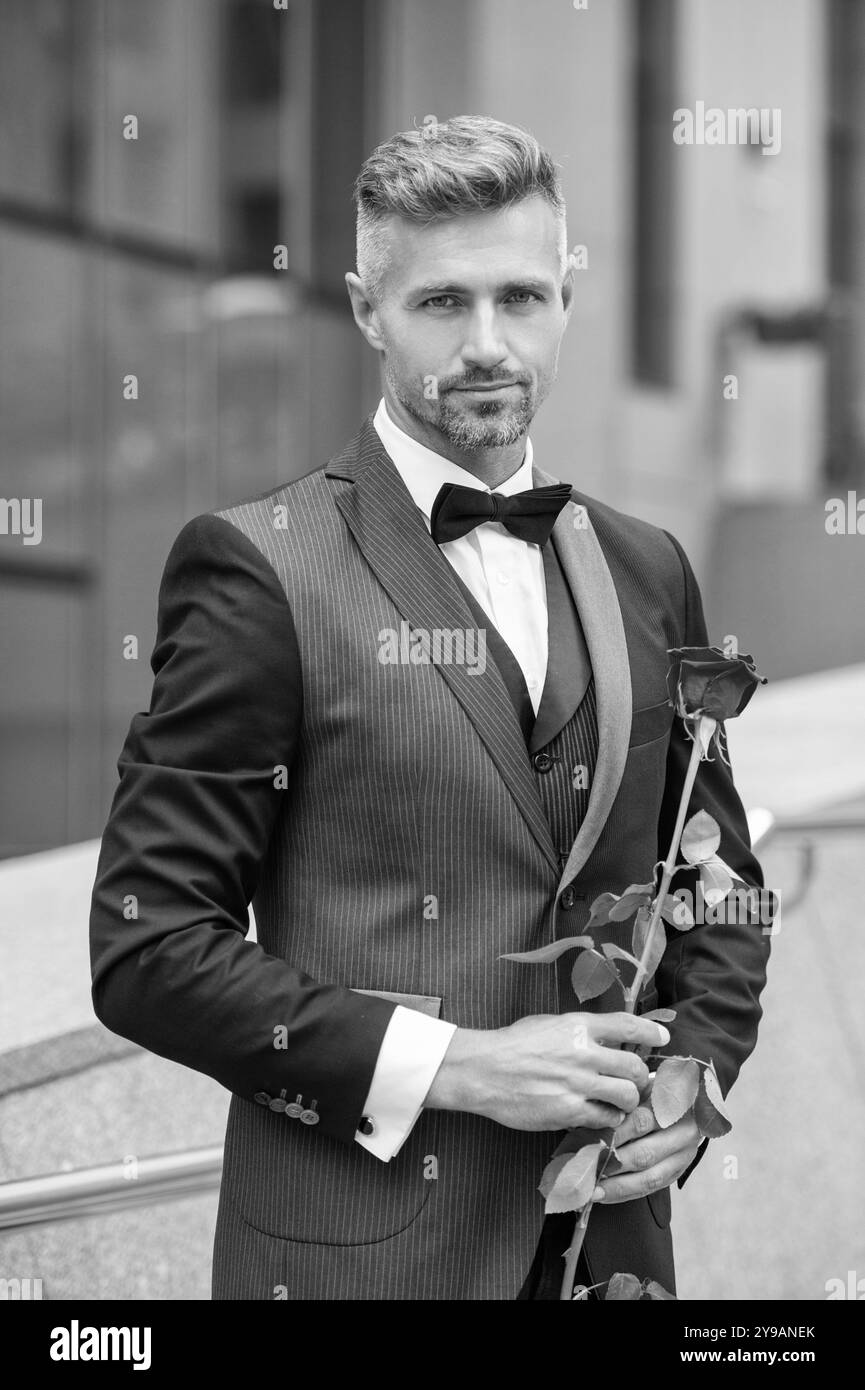 Man tuxedo handsome red rose Black and White Stock Photos & Images - Alamy