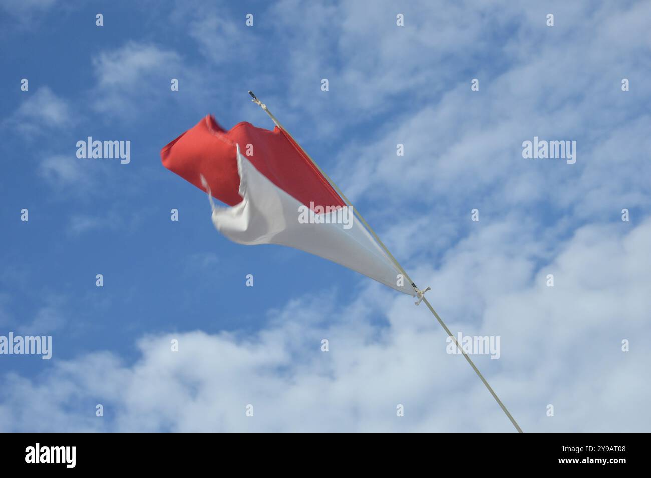 Red and White, Indonesia's flag fluttered against blue sky and white ...