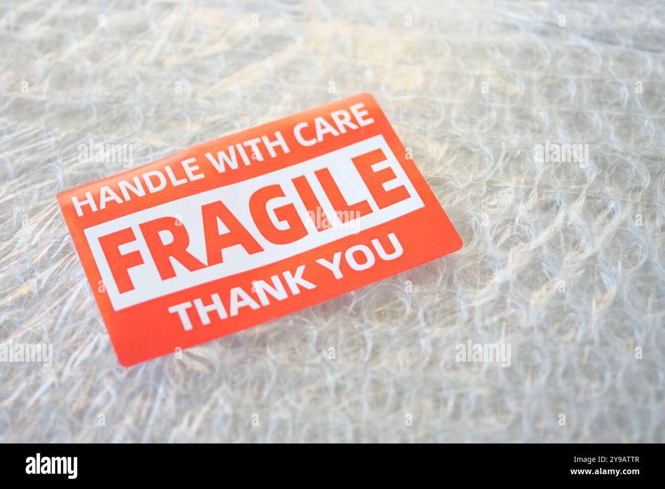 A cardboard box marked with a caution label for fragile goods handling during shipping Stock ...