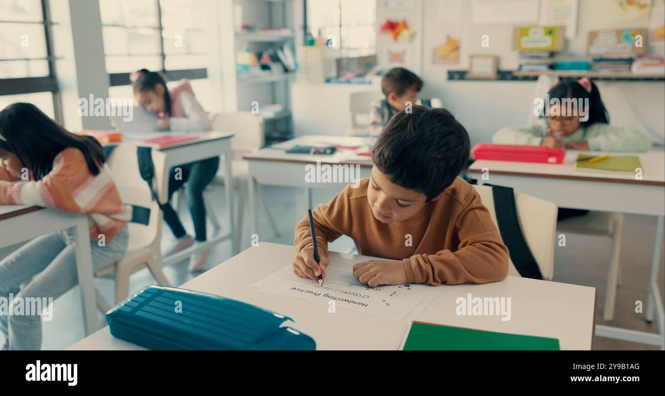 Student, boy and child with writing in classroom for literacy skills ...