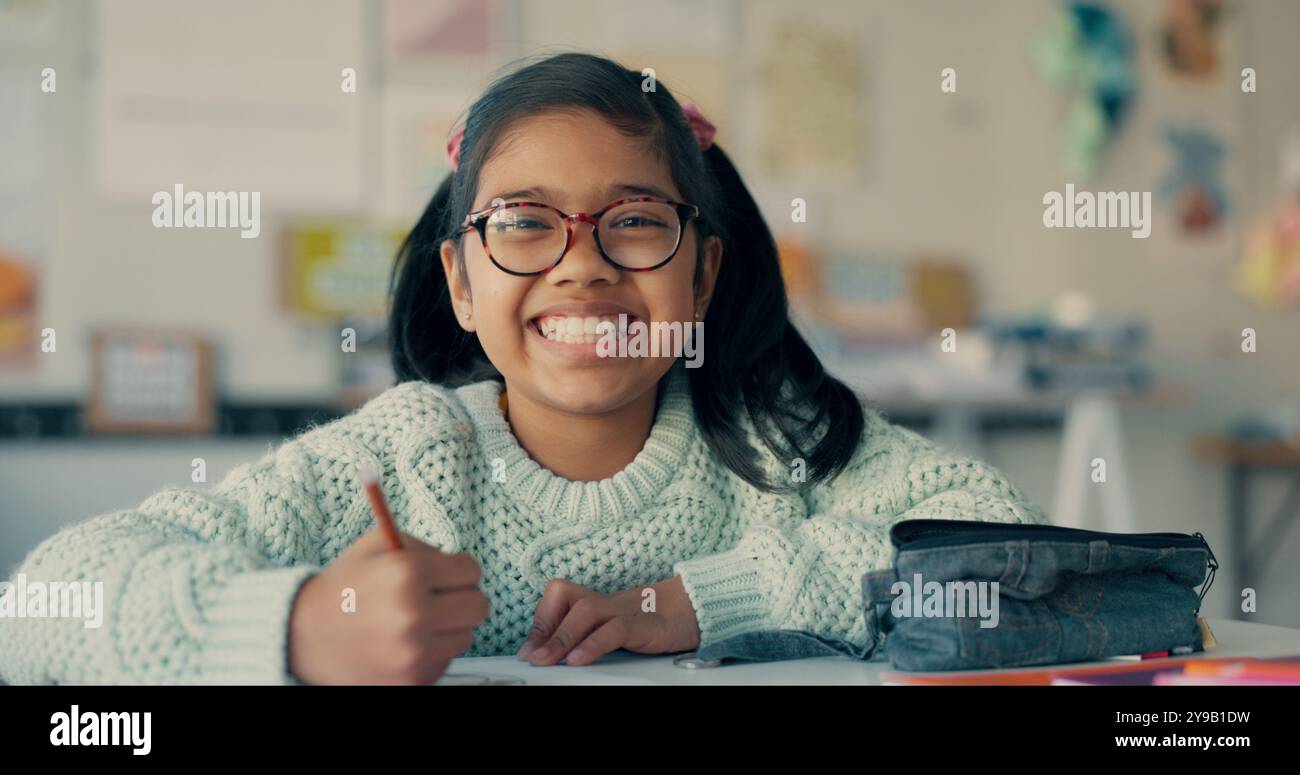 Girl, child and writing in classroom, portrait and smile with notes ...