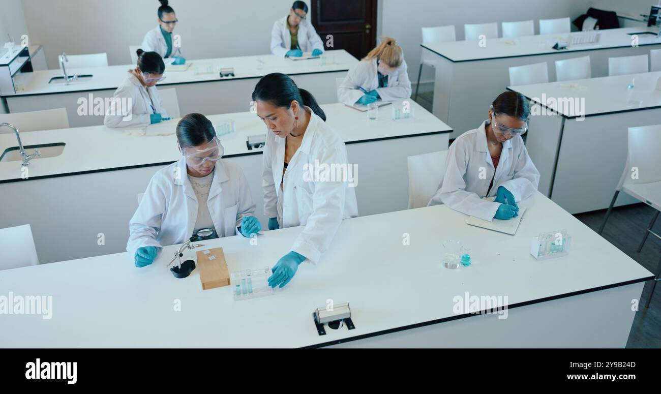 Science, students and learning in class with test tubes, PPE and ...