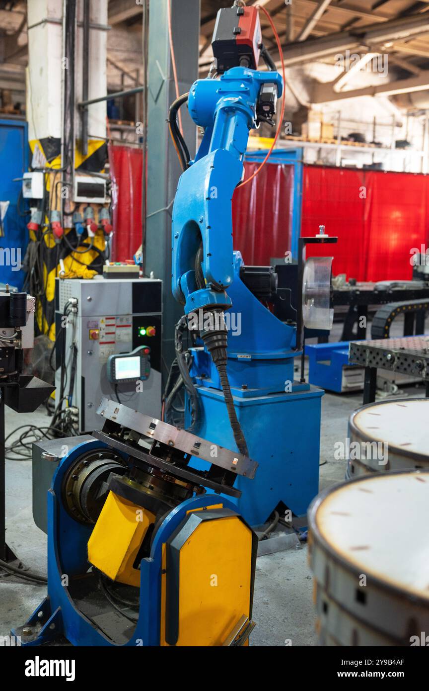 Automatic Industrial welding robot in a modern factory in operation ...