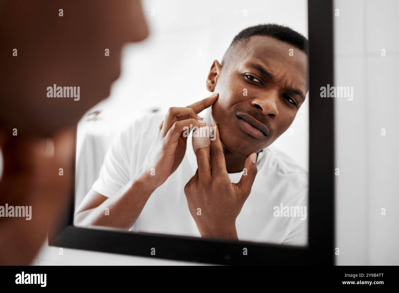 Skincare, black man and thinking in bathroom with mirror, touch and ...