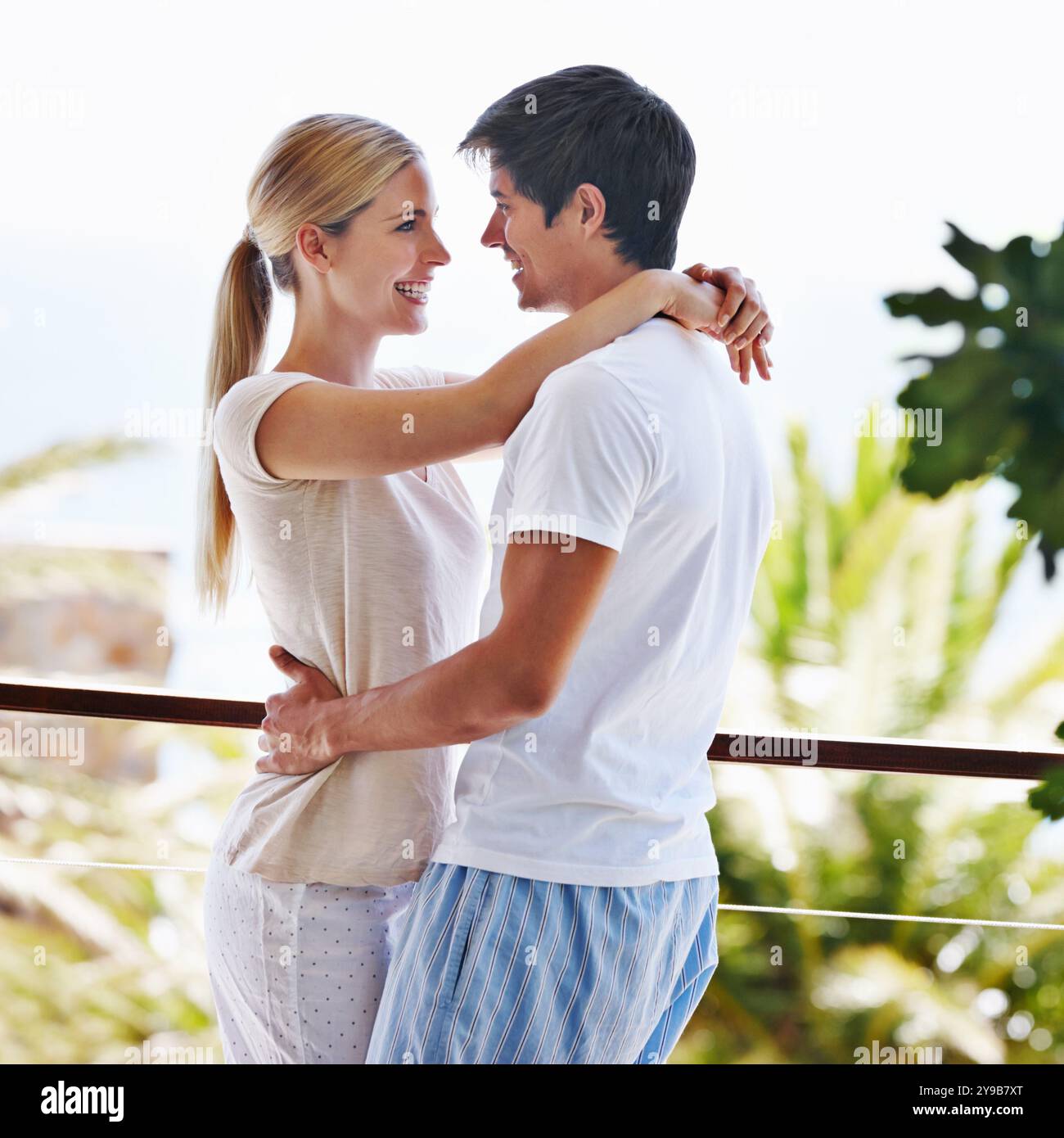 Balcony, couple or smile with hug for bonding, connection or commitment ...