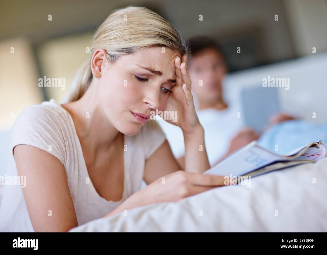 Home, woman and sad with magazine for reading, information and fight ...