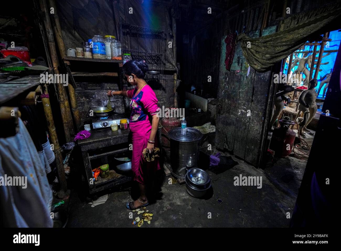 Sunita Paul, 31, prepares food for herself and other artisans preparing ...