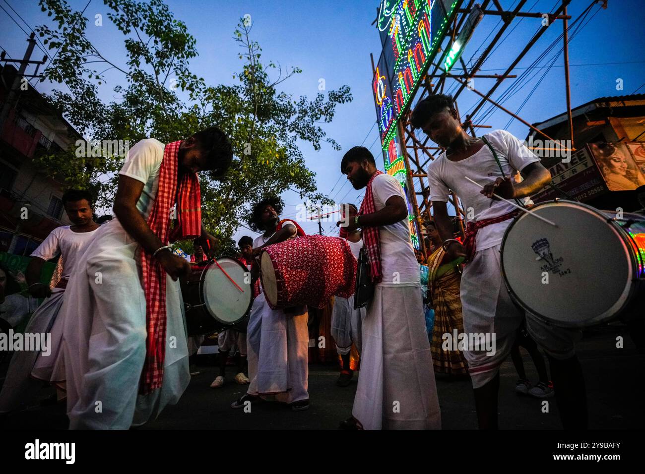 Hindu devotees carry out a ritual procession during the Durga Puja ...