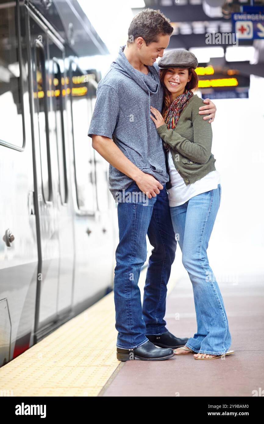 Hug, platform and love with couple at train station. for holiday ...