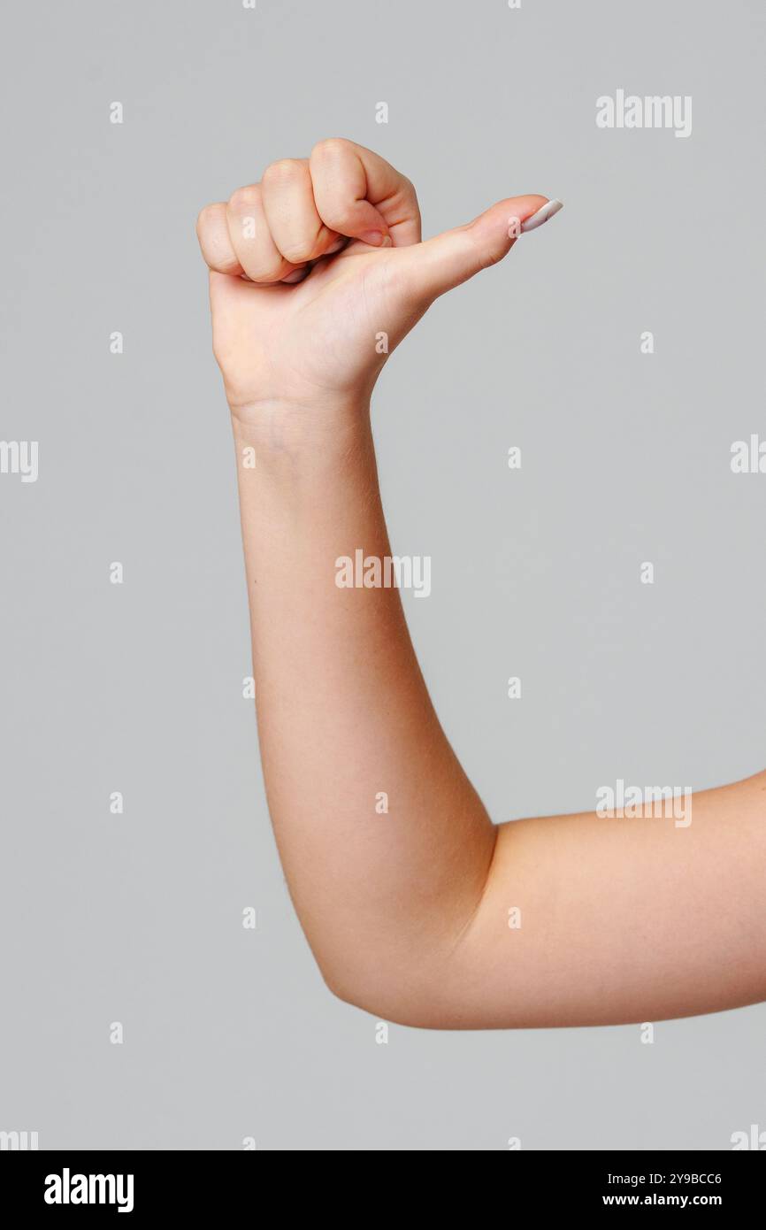hand with a thumbs up gesture against a neutral background Stock Photo ...
