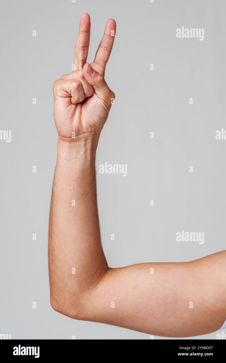 A person hand gesture against a neutral background Stock Photo - Alamy