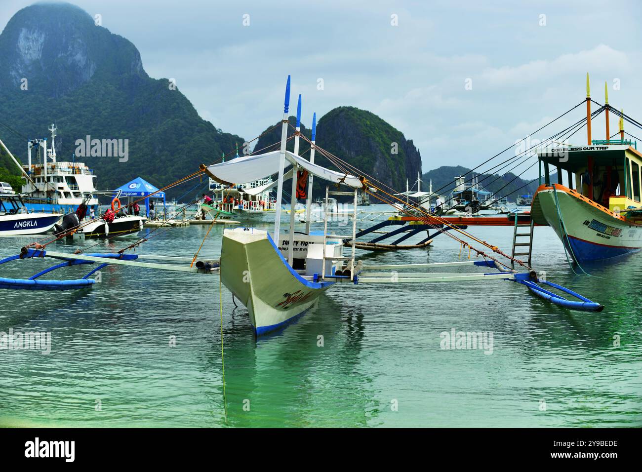 Close up view of Traditional wooden and bamboo boats Bangkas docked on ...