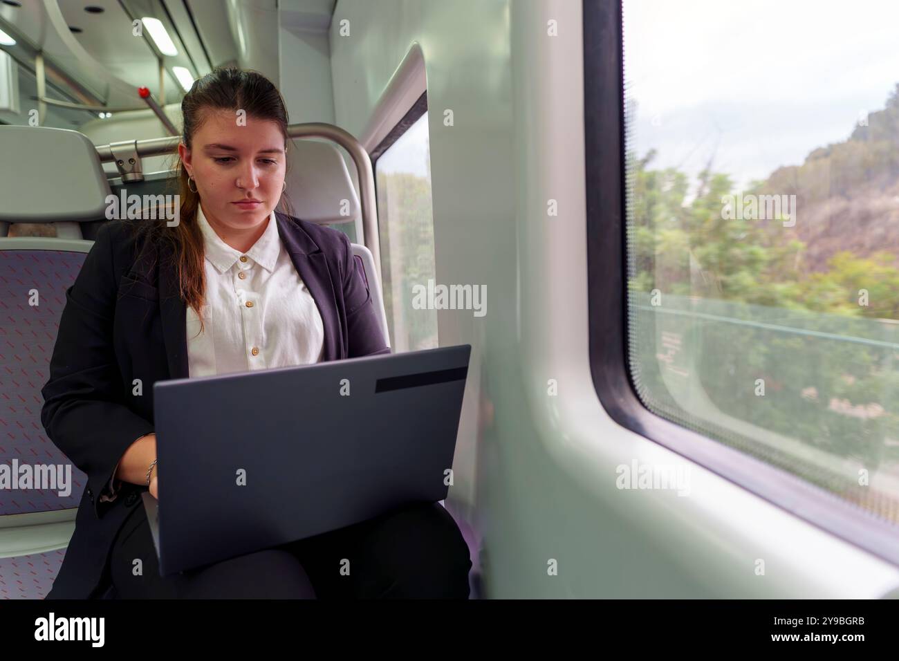 Young Businesswoman Working on Laptop While Traveling by Train Stock ...