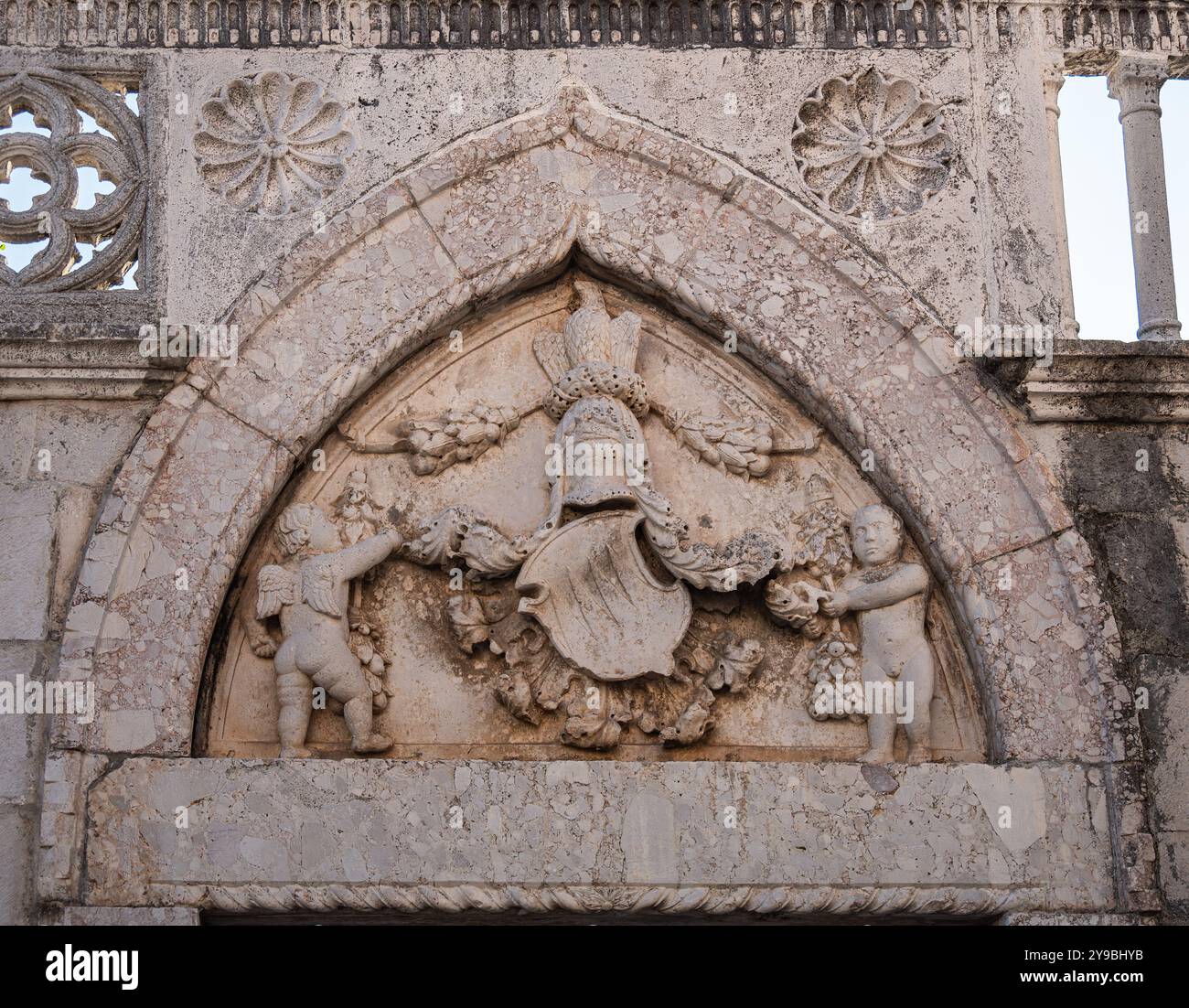 Rab, Croatia - 19 August, 2023: Detailed stone relief with crown-topped ...