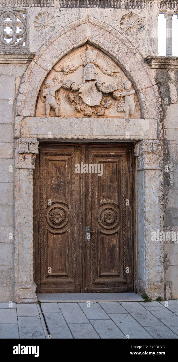 Rab, Croatia - 19 August, 2023: A historic wooden door in a stone ...
