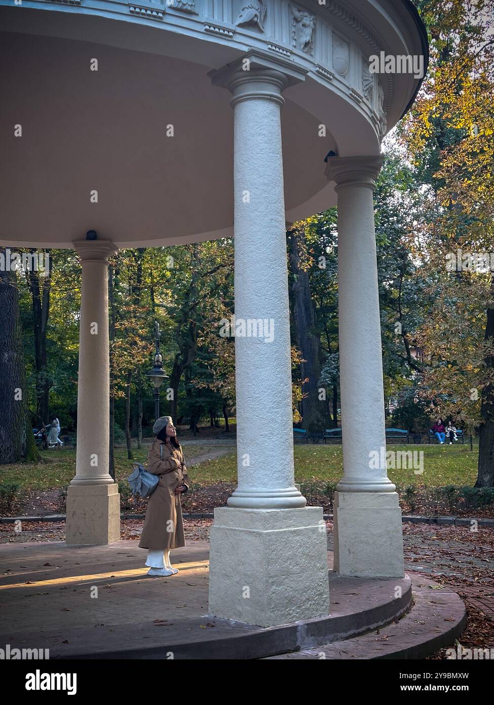 Woman standing under trees hi-res stock photography and images - Alamy