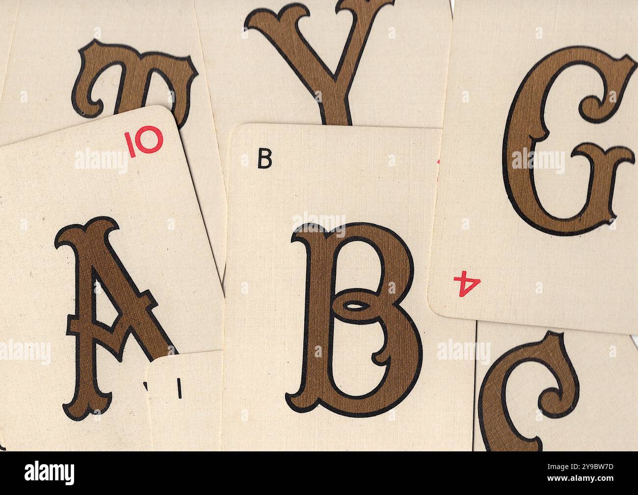 A montage of vintage playing cards with ornate capital letters from the ...