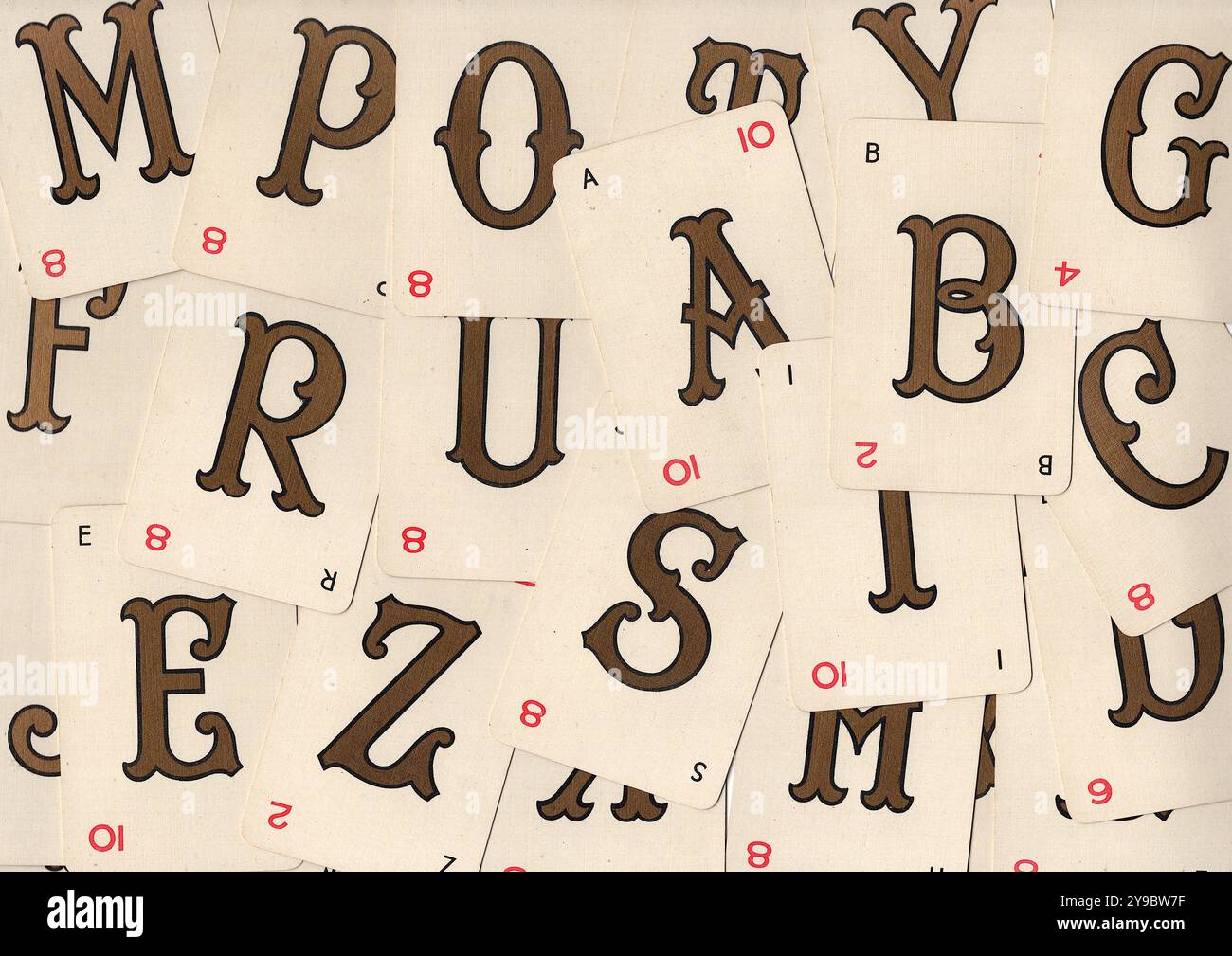 A montage of vintage playing cards with ornate capital letters from the ...