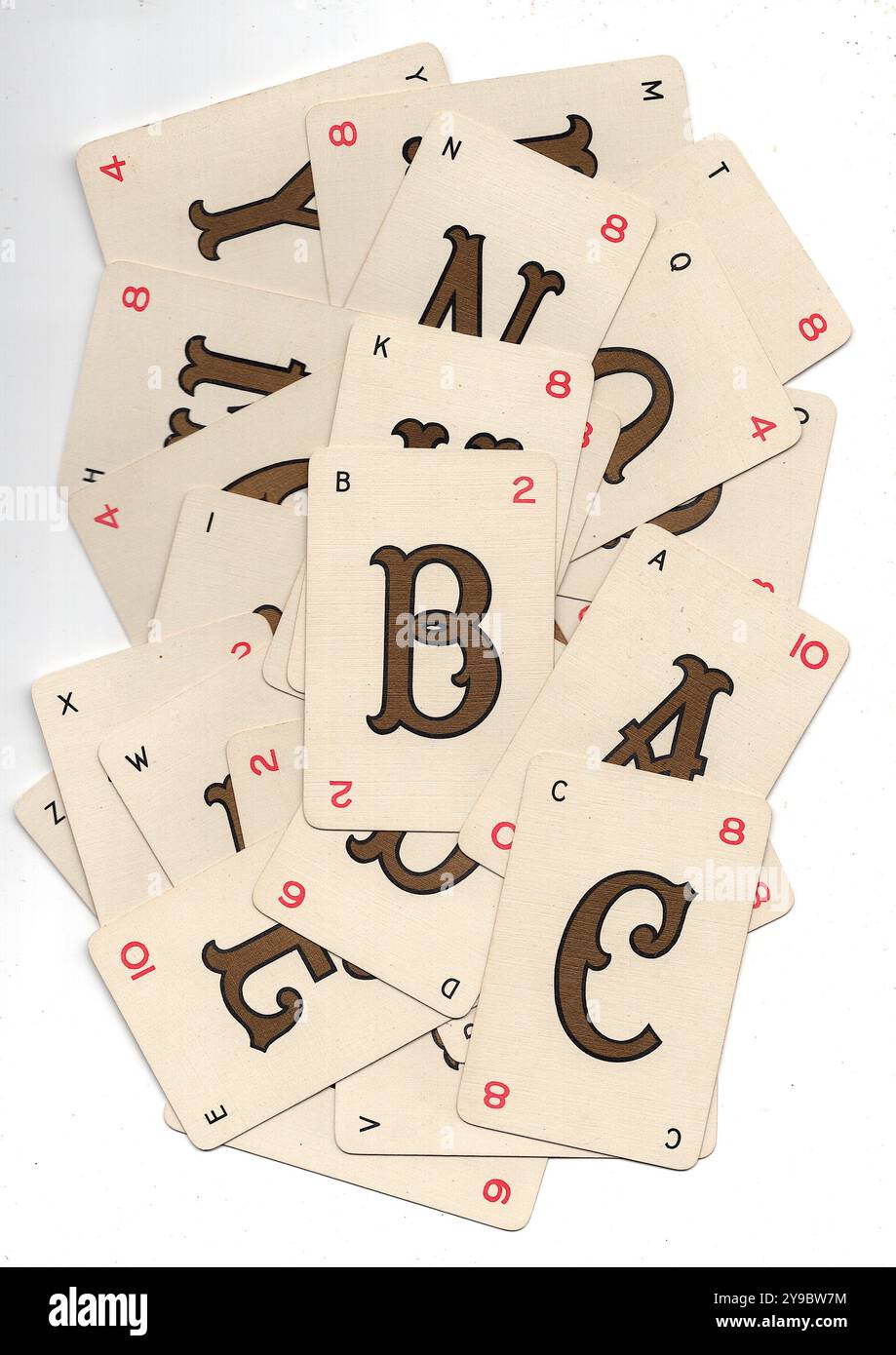 A montage of vintage playing cards with ornate capital letters from the ...