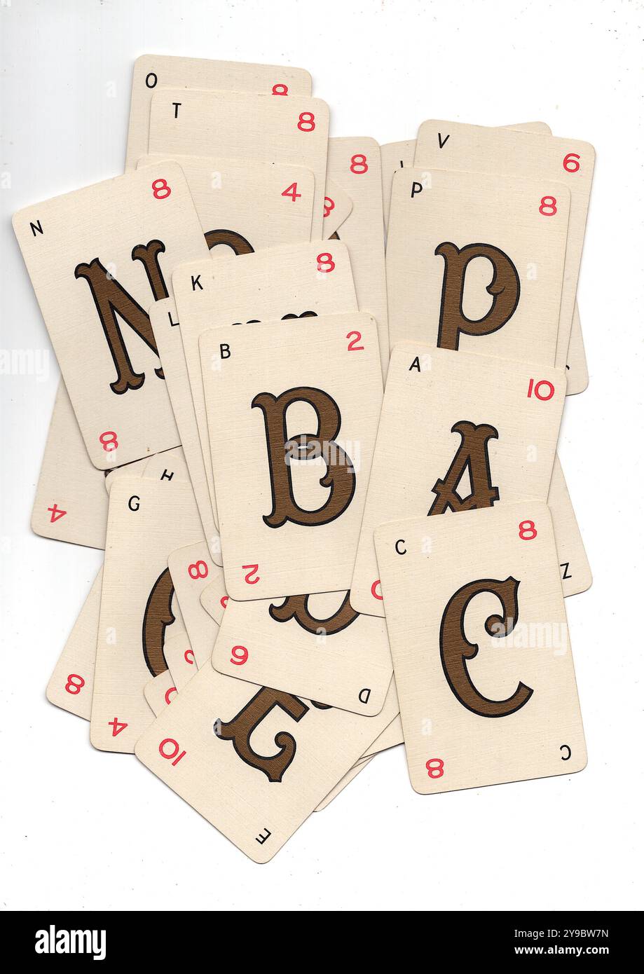 A montage of vintage playing cards with ornate capital letters from the ...