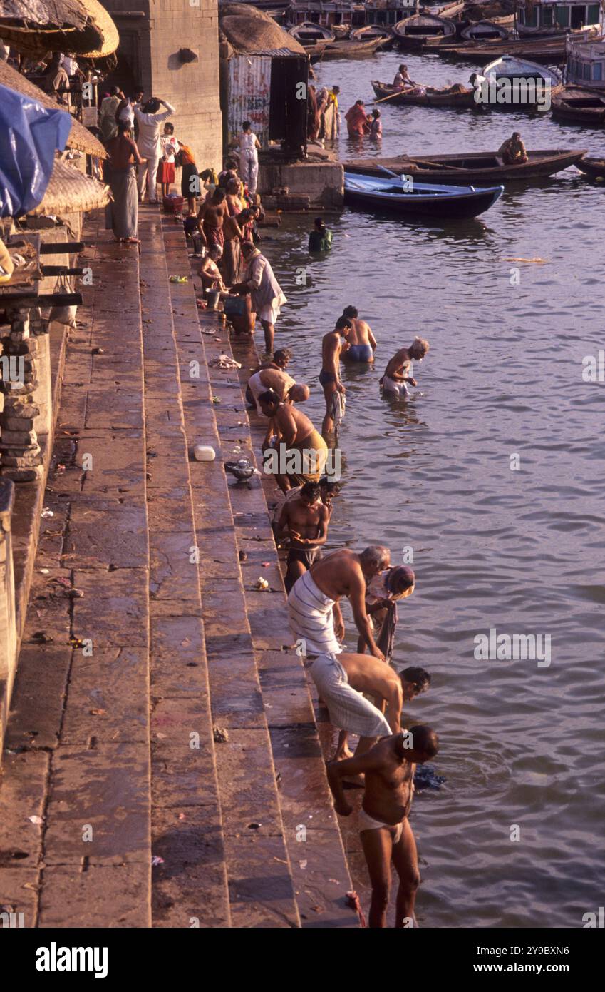 India, Varanasi, Hindu pilgrims bathing in the ganges, sunrise Stock ...