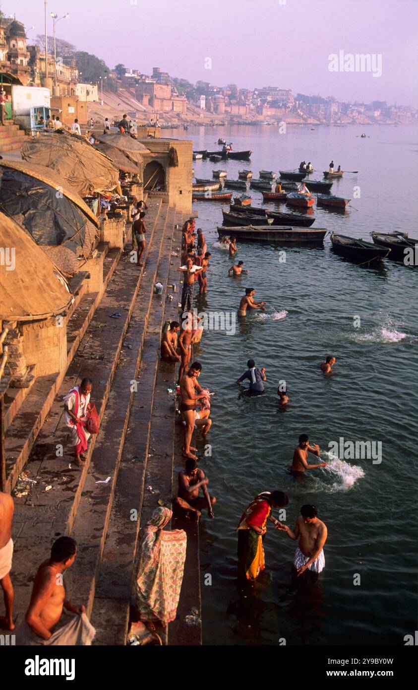 India, Varanasi, Hindu pilgrims bathing in the ganges, sunrise Stock ...