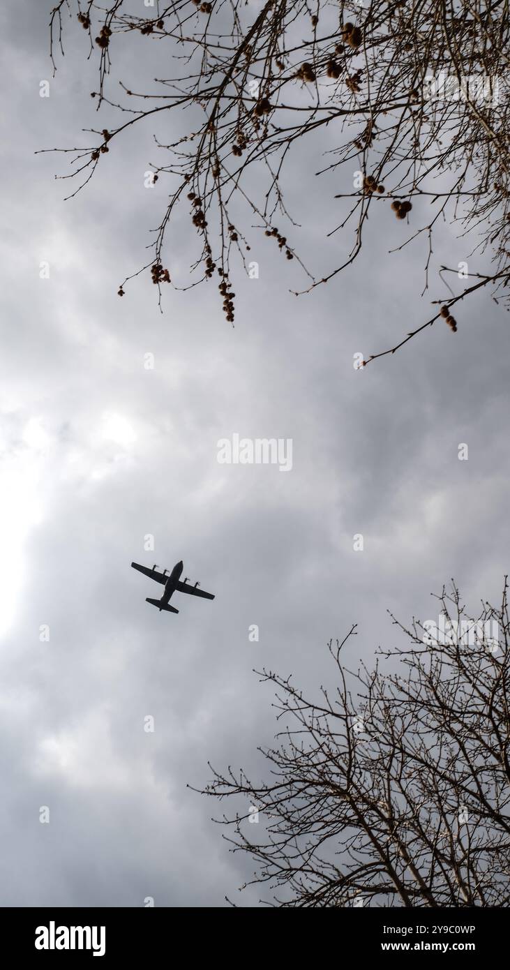 Cargo plane flying in cloudy weather Stock Photo - Alamy