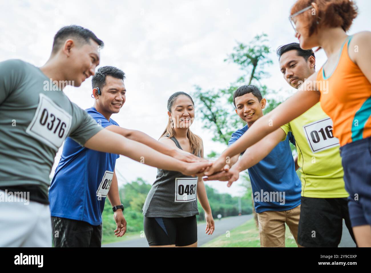 asian runners showing their good teamwork Stock Photo - Alamy