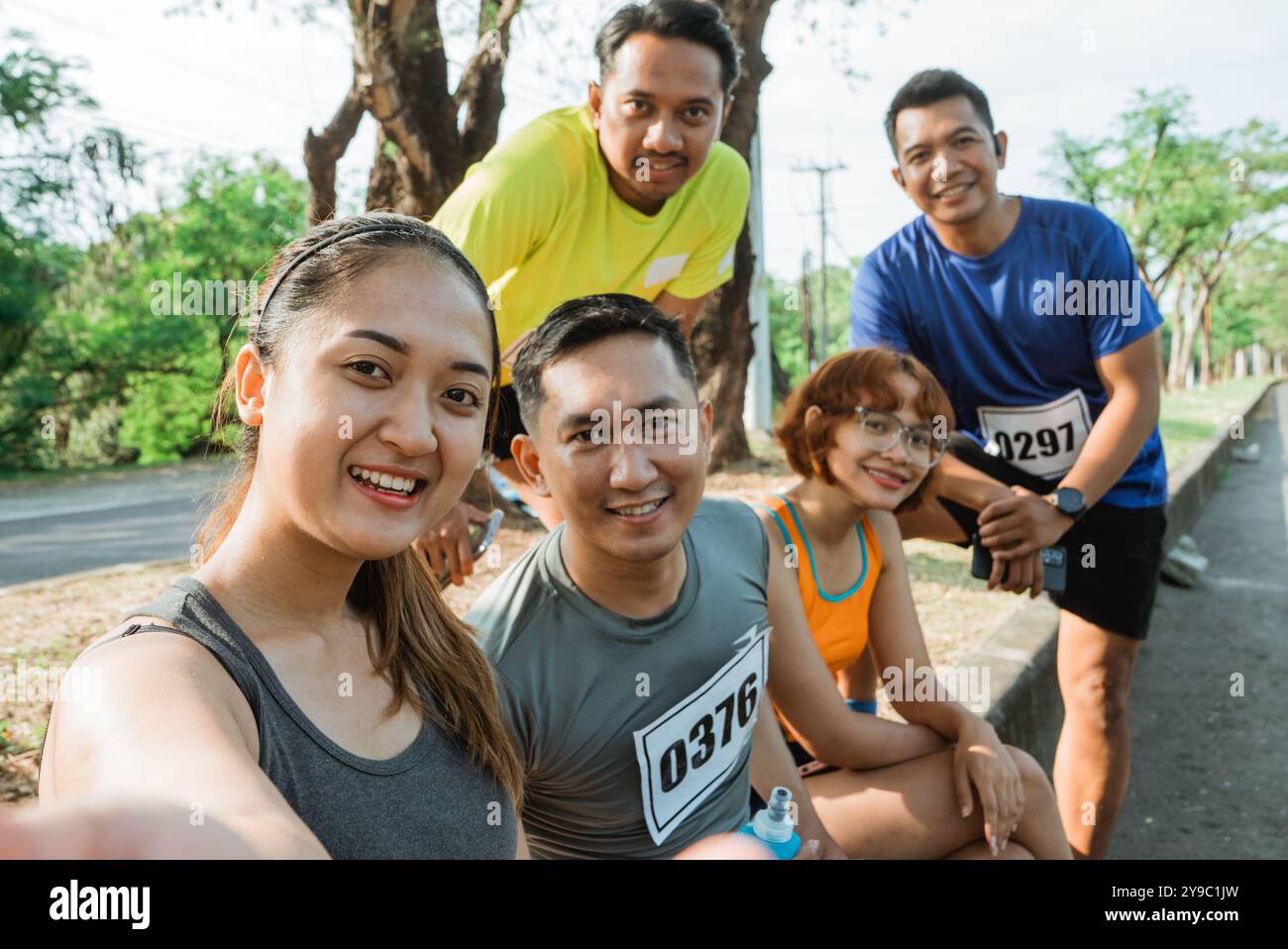 asian marathon runner sitting and posing together Stock Photo - Alamy