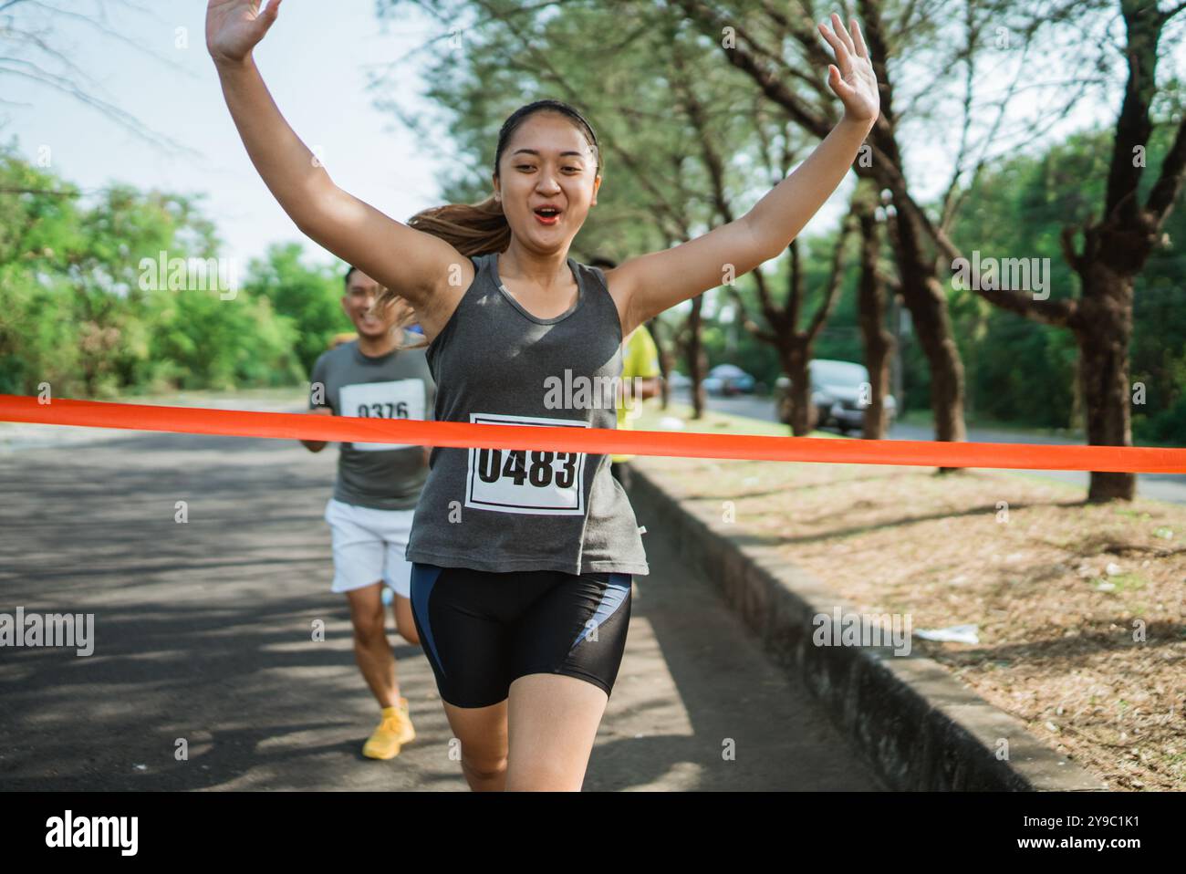 happy marathon participant crossing finish line Stock Photo - Alamy