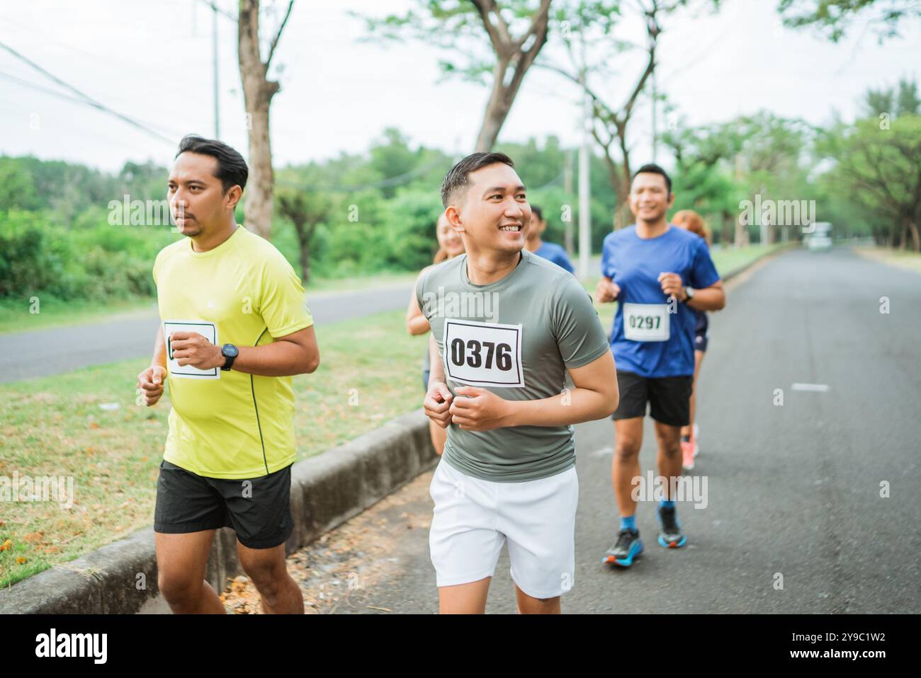 asian male athlete leading another marathon runner Stock Photo - Alamy