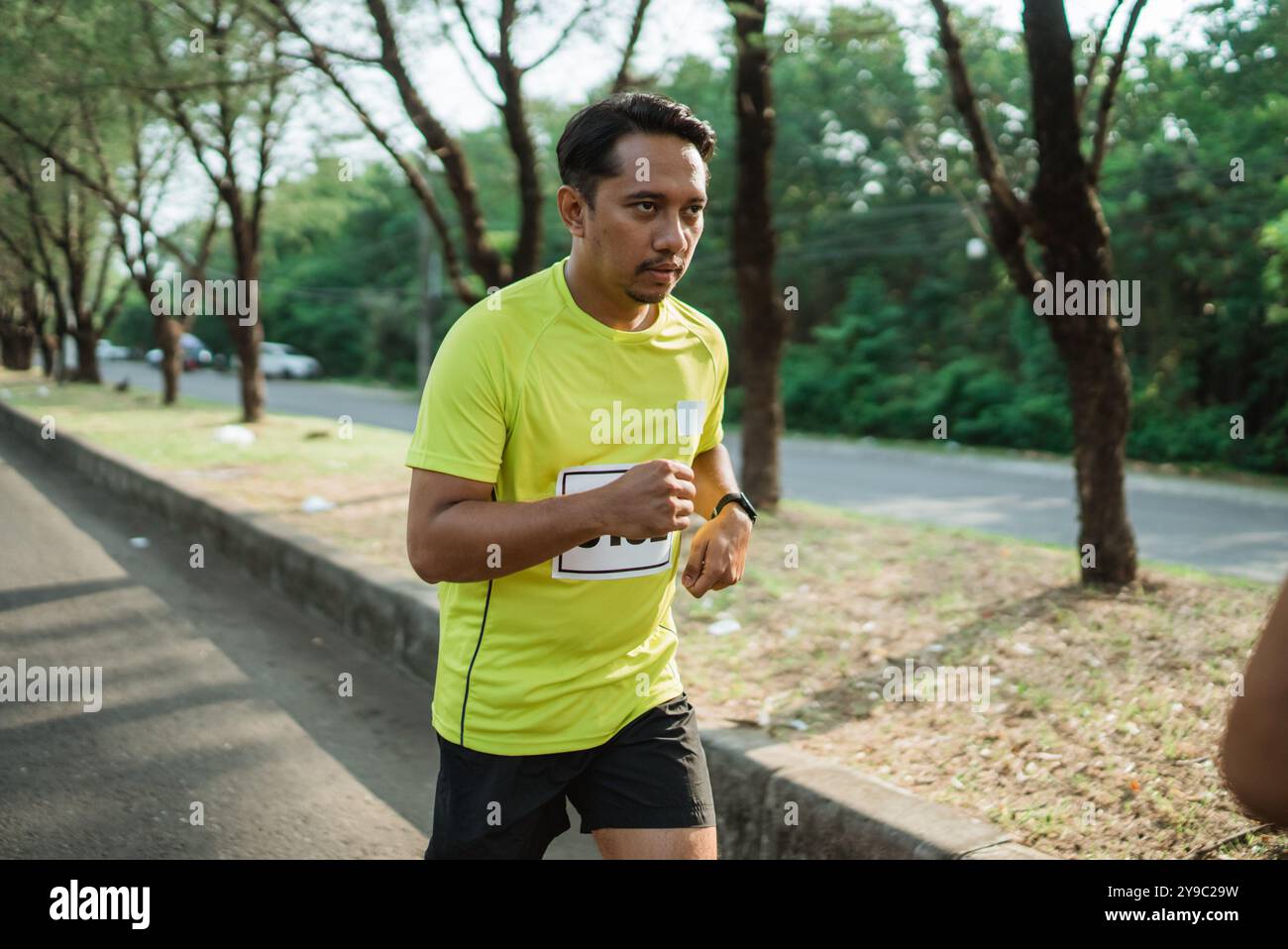 asian male athlete running marathon track Stock Photo - Alamy
