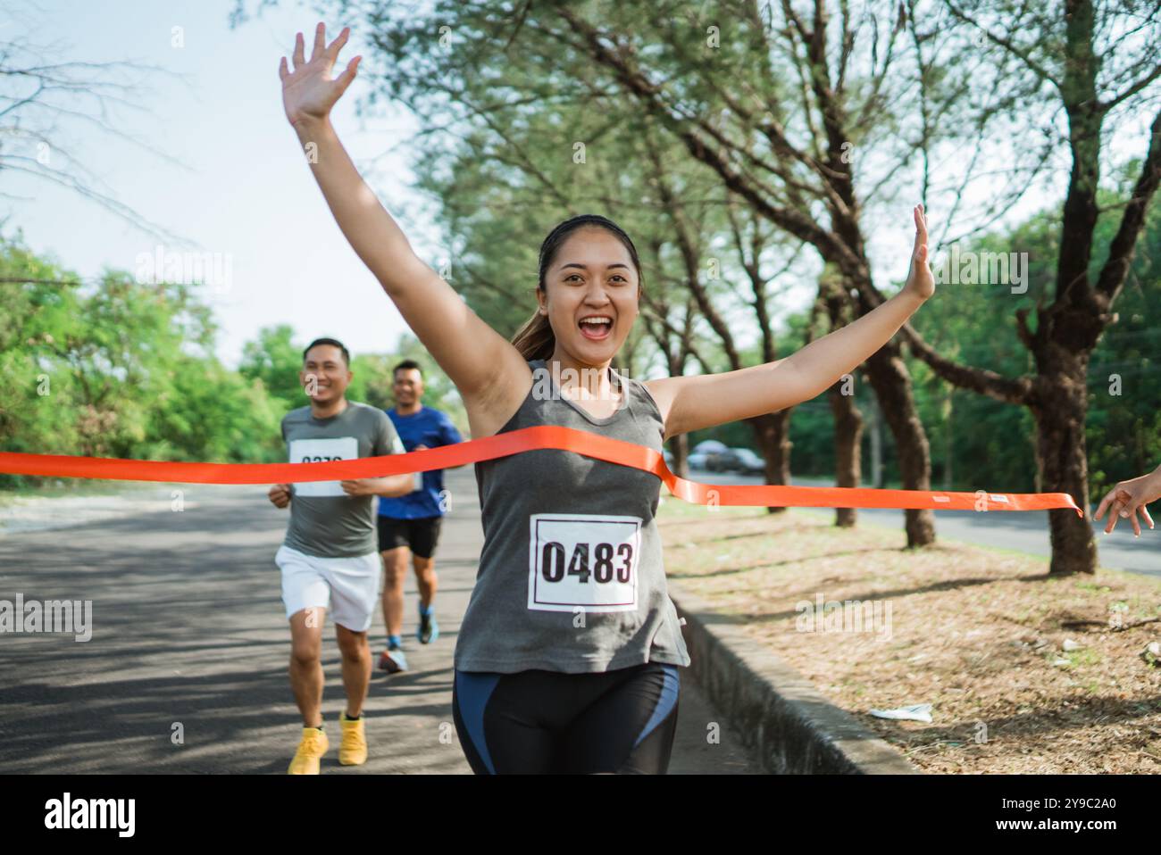 happy marathon participant crossing finish line Stock Photo - Alamy