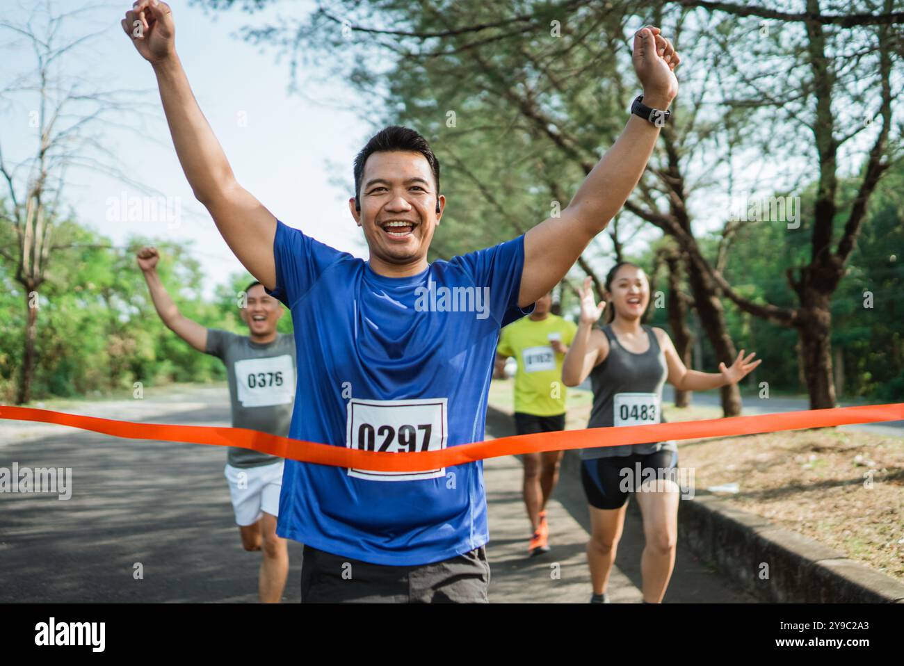 male athlete crossing marathon finish line Stock Photo - Alamy