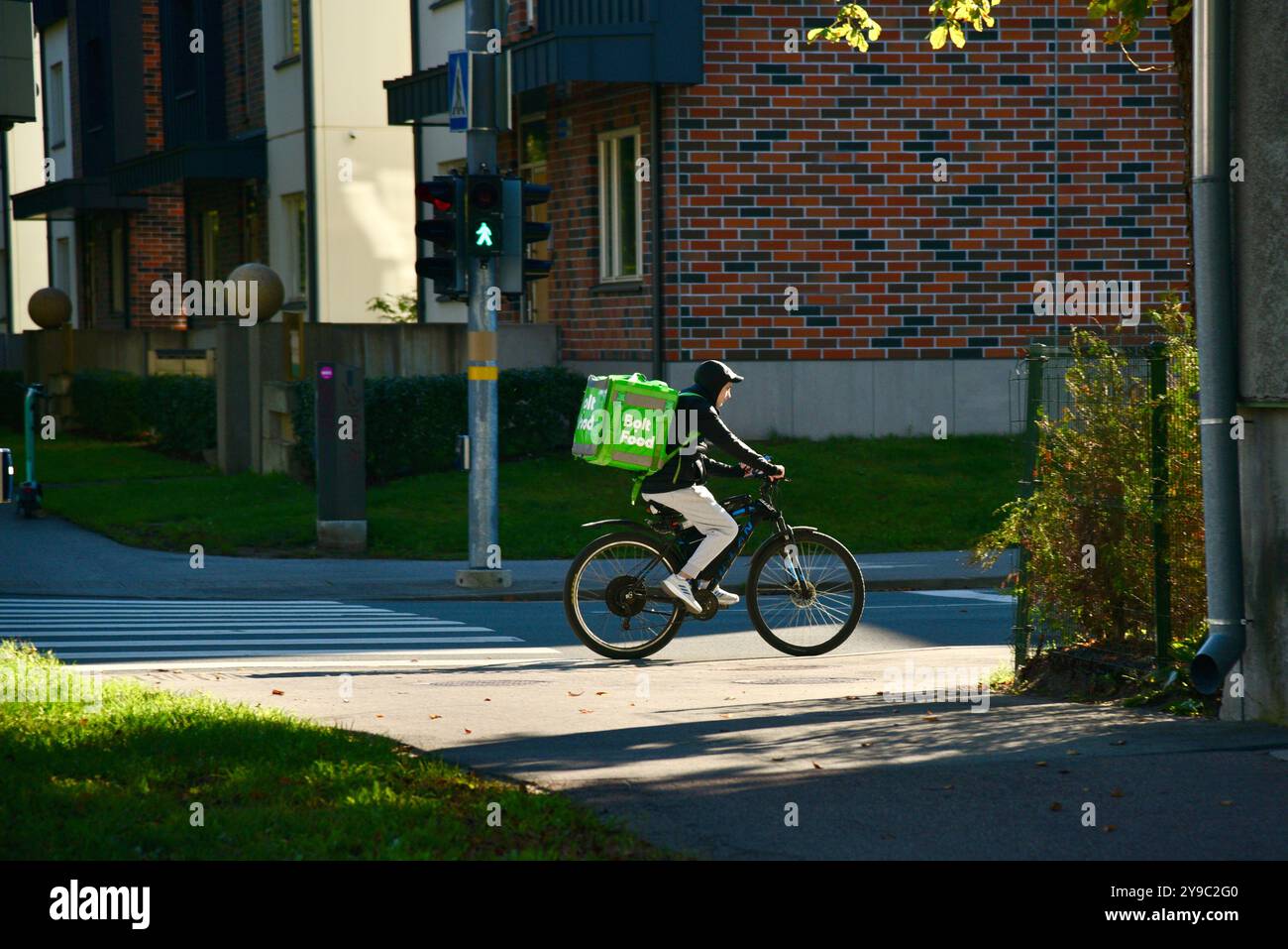 Bolt delivery person making food delivery on bicycle near Bolt ...
