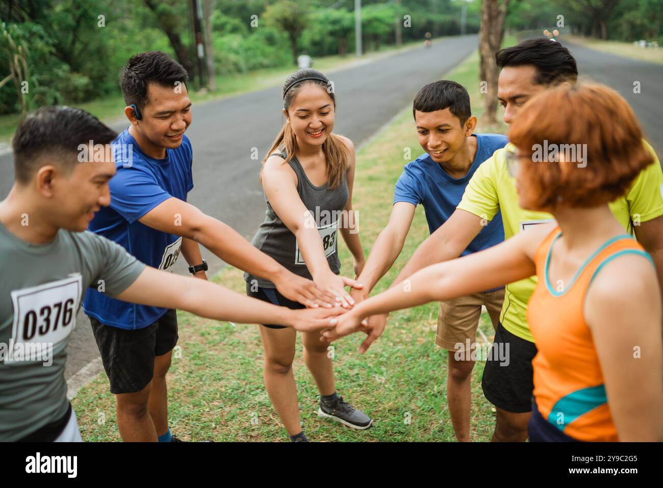 asian runners putting their hands together Stock Photo - Alamy