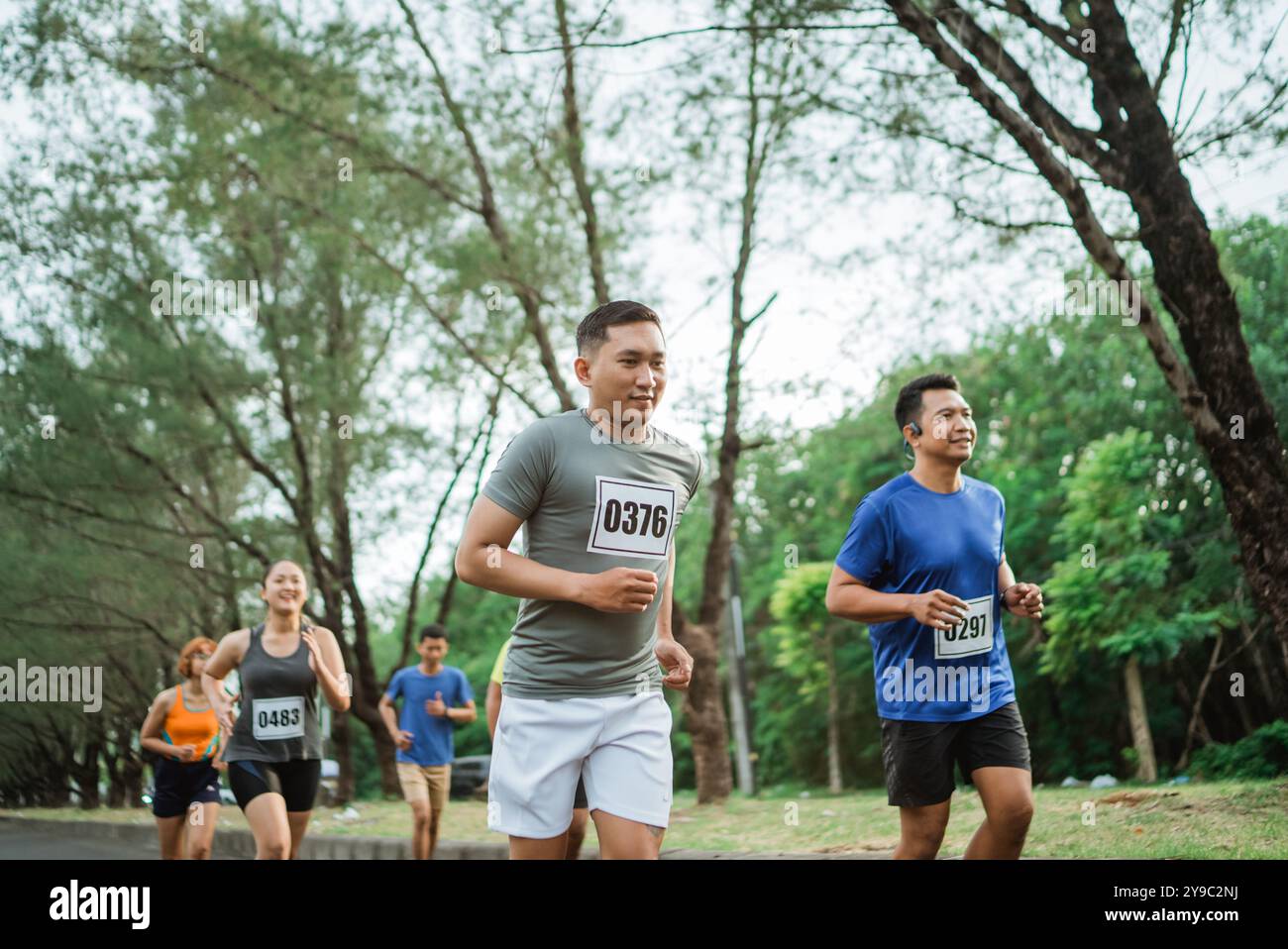 sporty man running through marathon track Stock Photo - Alamy