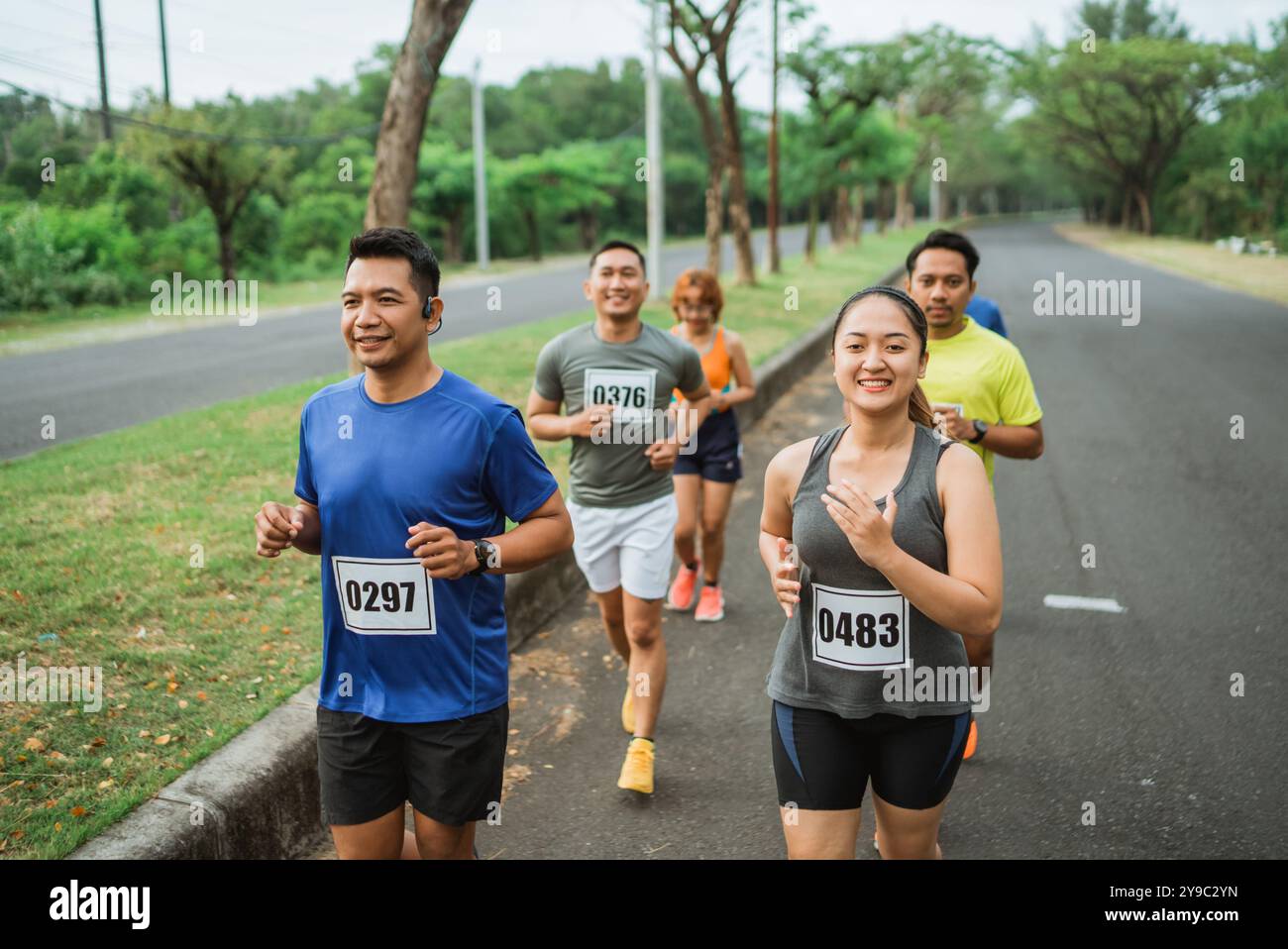 group of athletic people running on outdoor track Stock Photo - Alamy