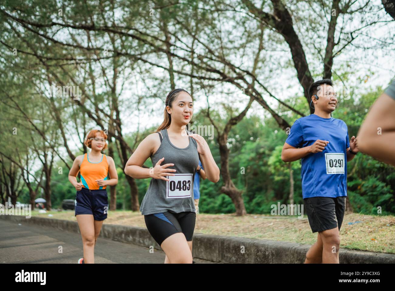 fit asian woman running on marathon event Stock Photo - Alamy