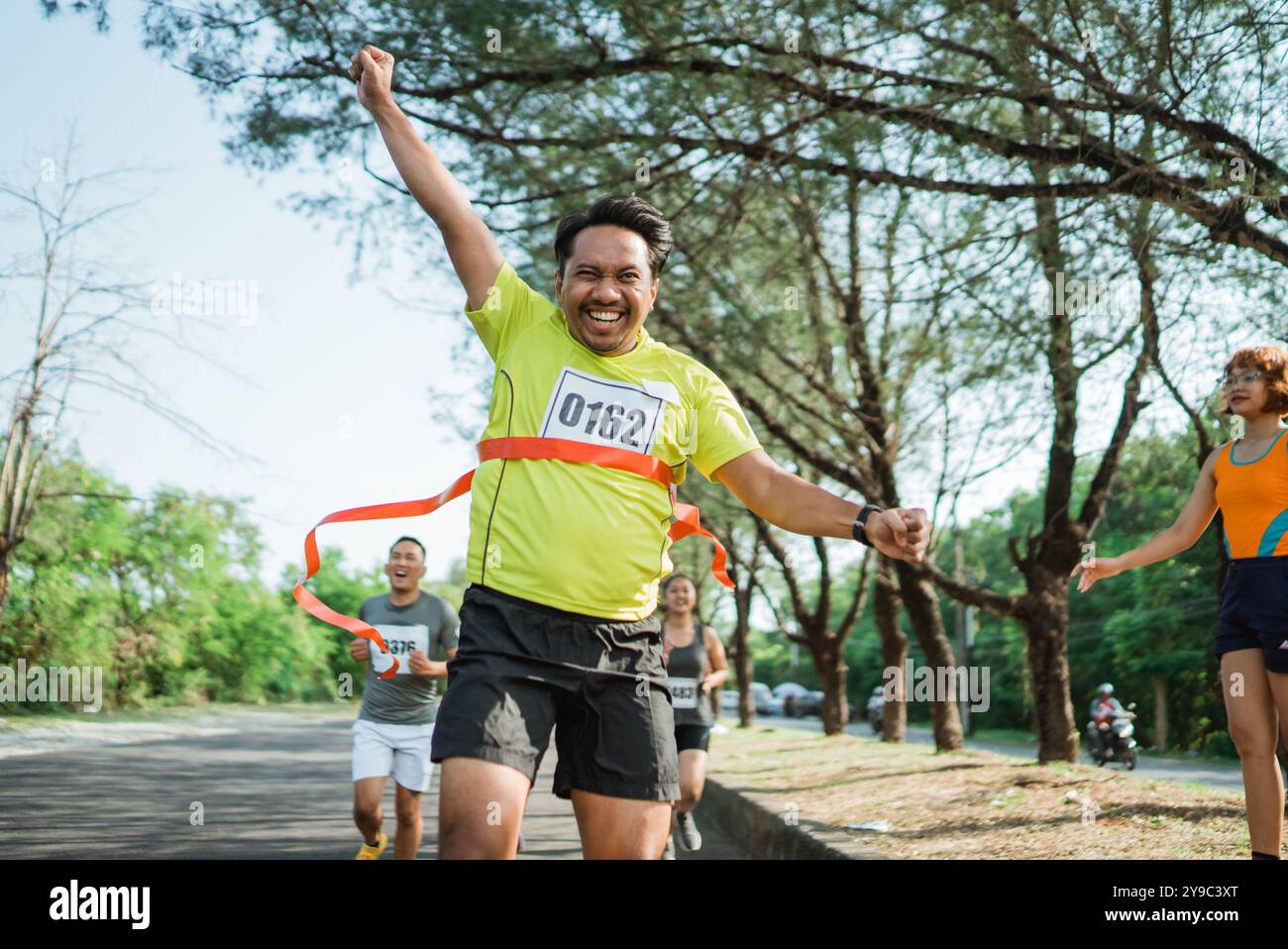 happy marathon winner with hands up gesture Stock Photo - Alamy