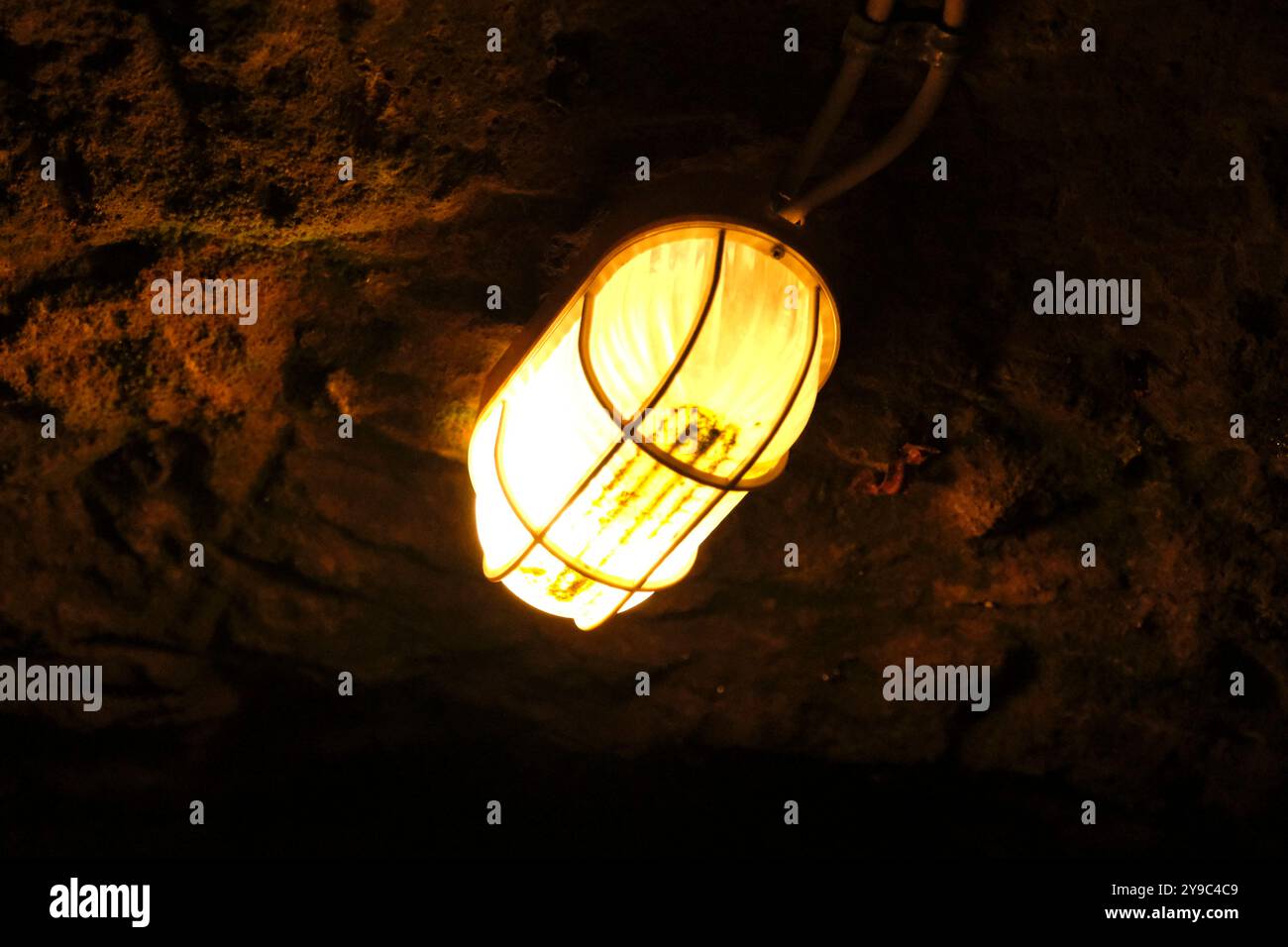 Old lantern lighting a stone wall Stock Photo - Alamy