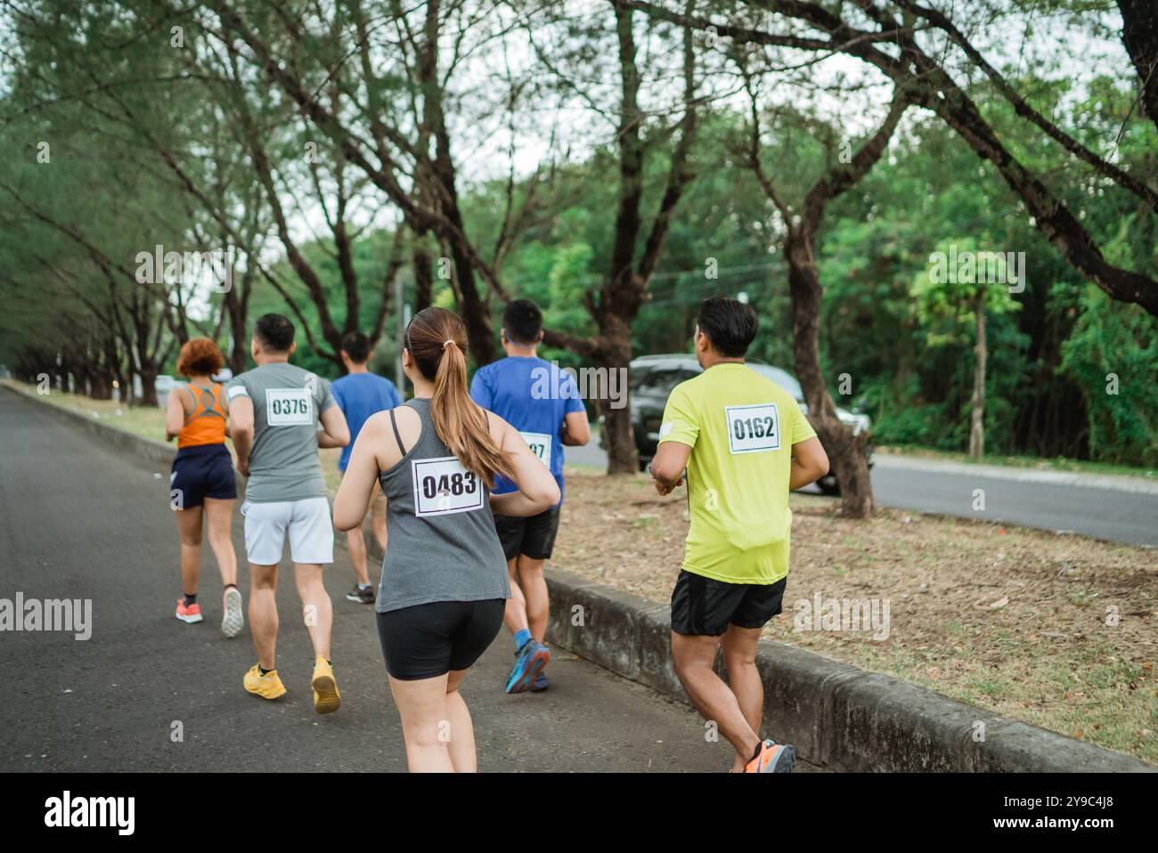 sporty marathon athlete running in the street Stock Photo - Alamy
