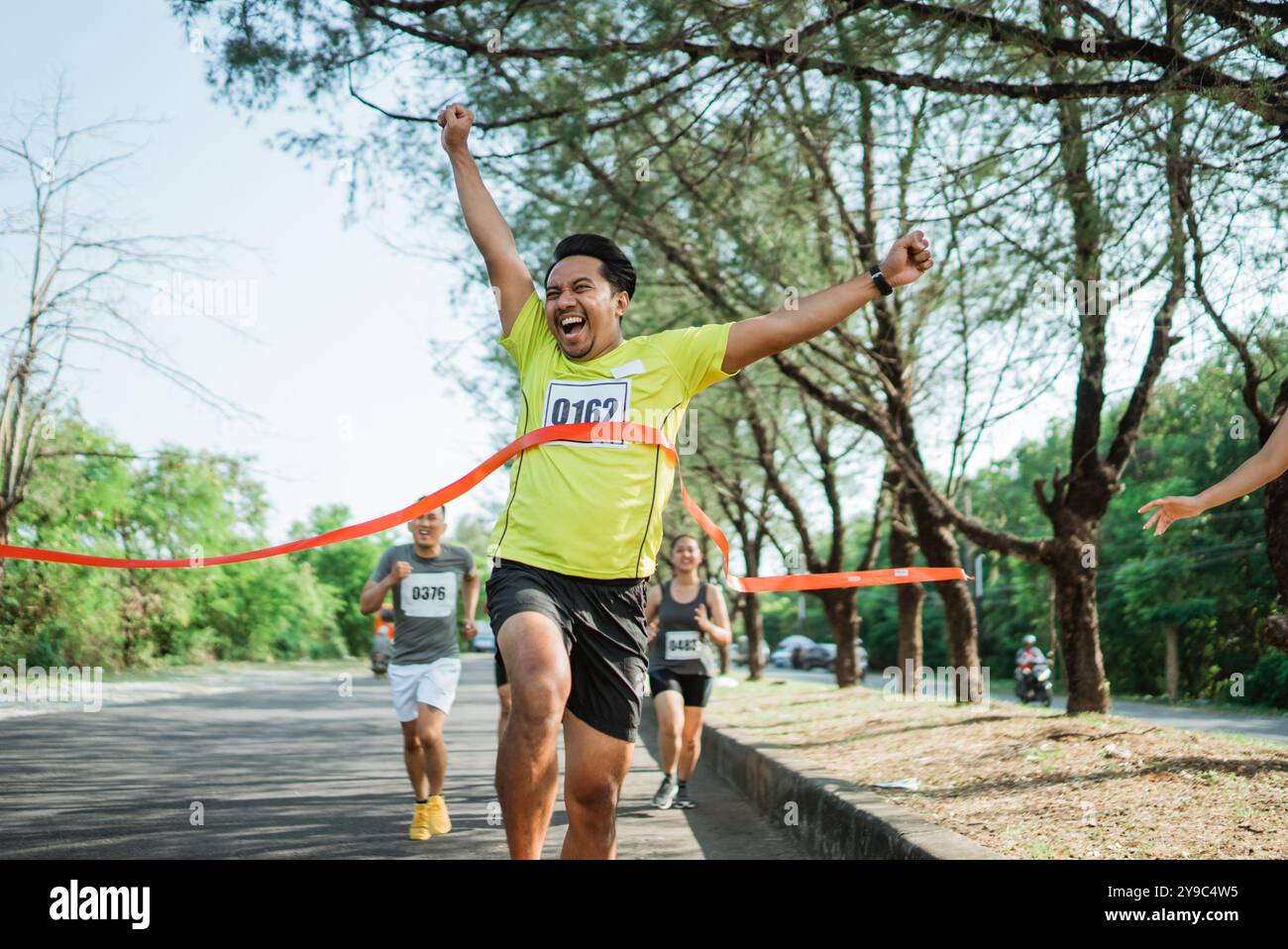 happy marathon winner with hands up gesture Stock Photo - Alamy
